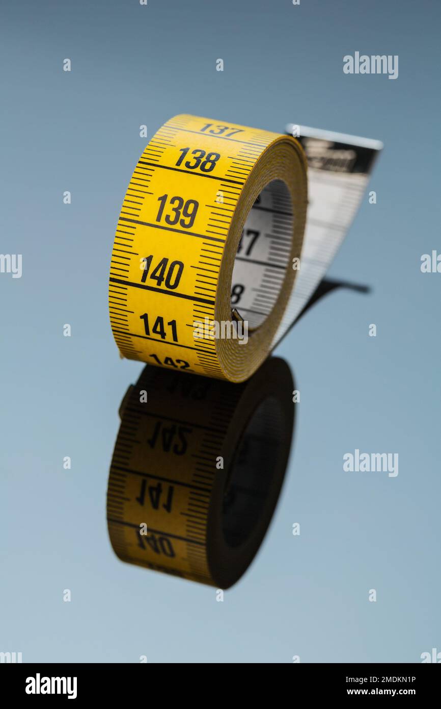 rolled-up yellow measuring tape Stock Photo - Alamy