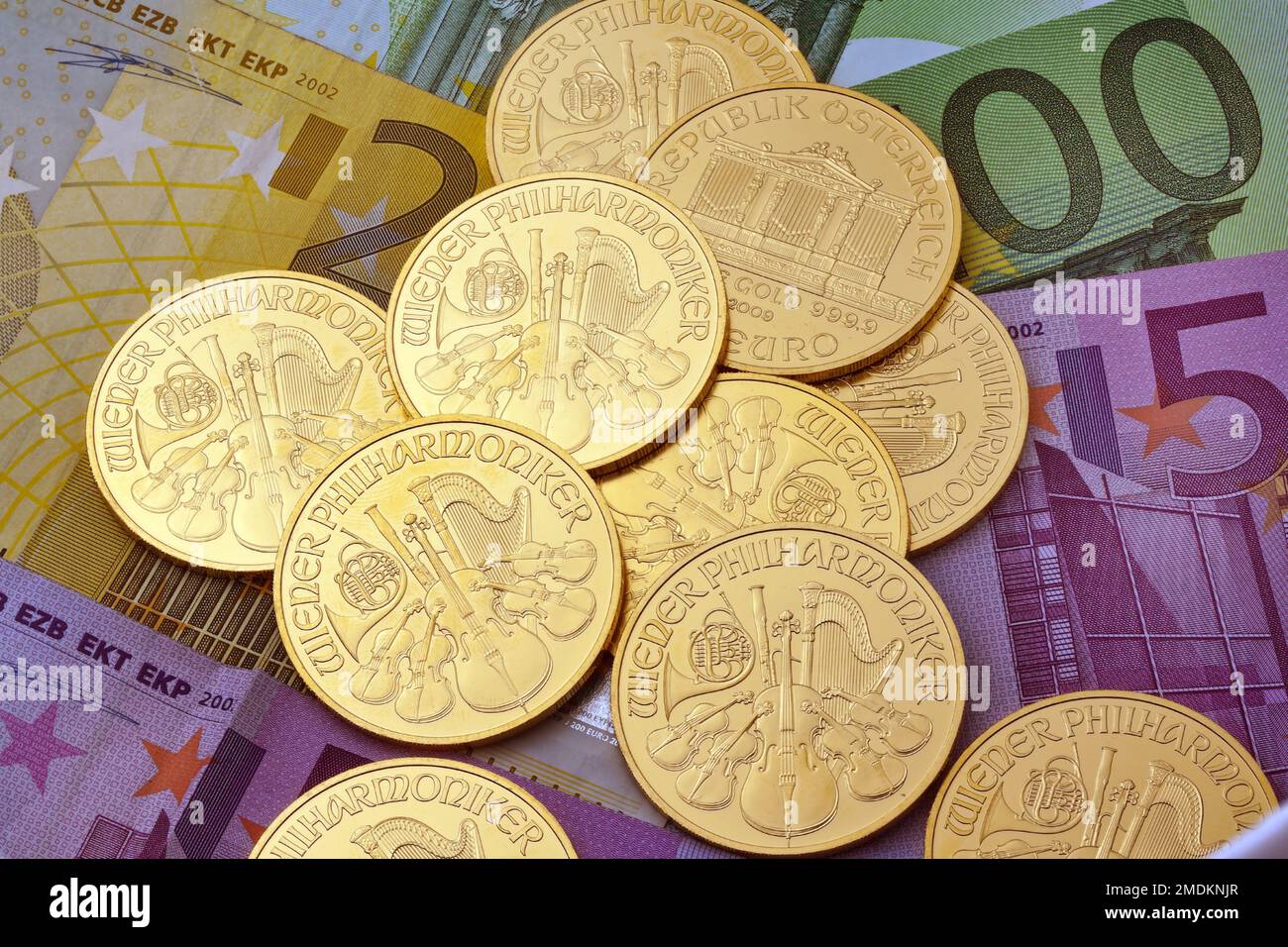 Vienna Philharmonic coins on different Euro bills Stock Photo - Alamy