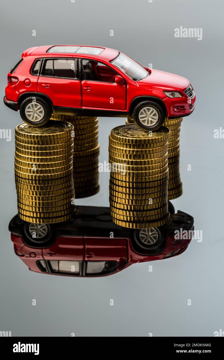 car on coin piles, increasing costs for a car, composing Stock Photo ...