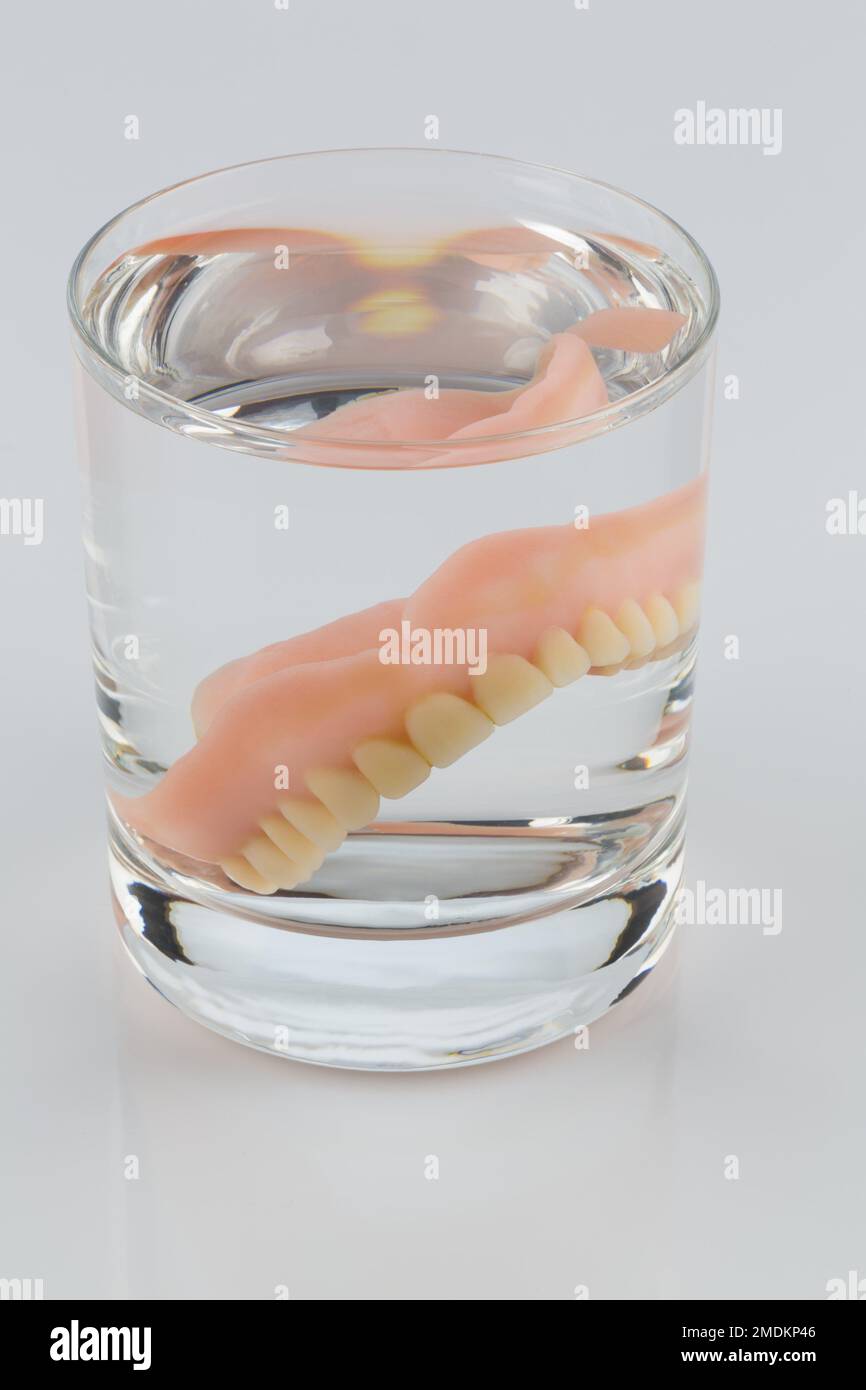 dental prosthesis in a water glass Stock Photo - Alamy