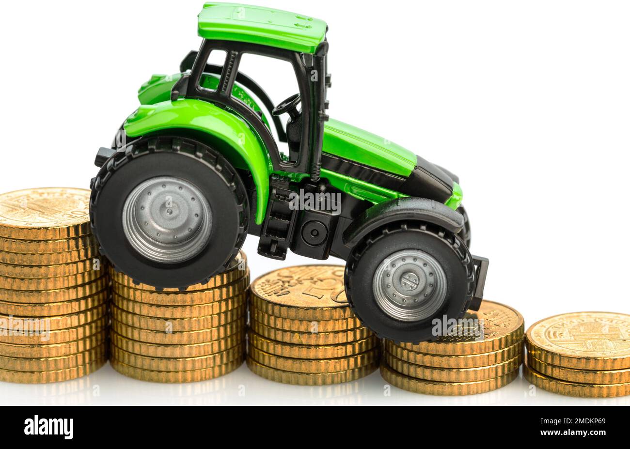 tractor on coin piles, decrasing profits in agriculture sector ...