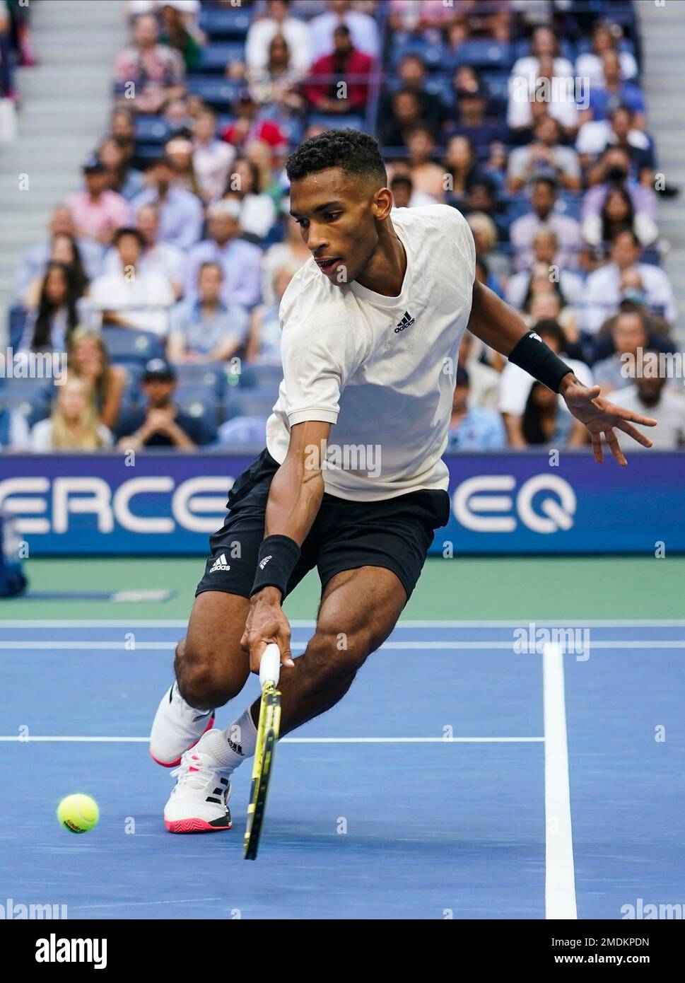 Felix Auger-Aliassime, of Canada, returns a shot to Daniil Medvedev, of Russia, during the ...