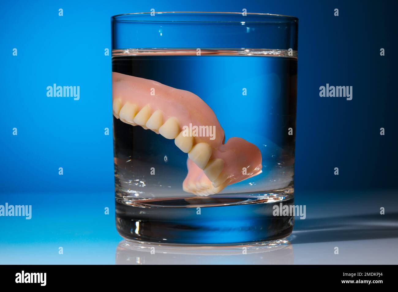 dental prosthesis in a water glass Stock Photo - Alamy
