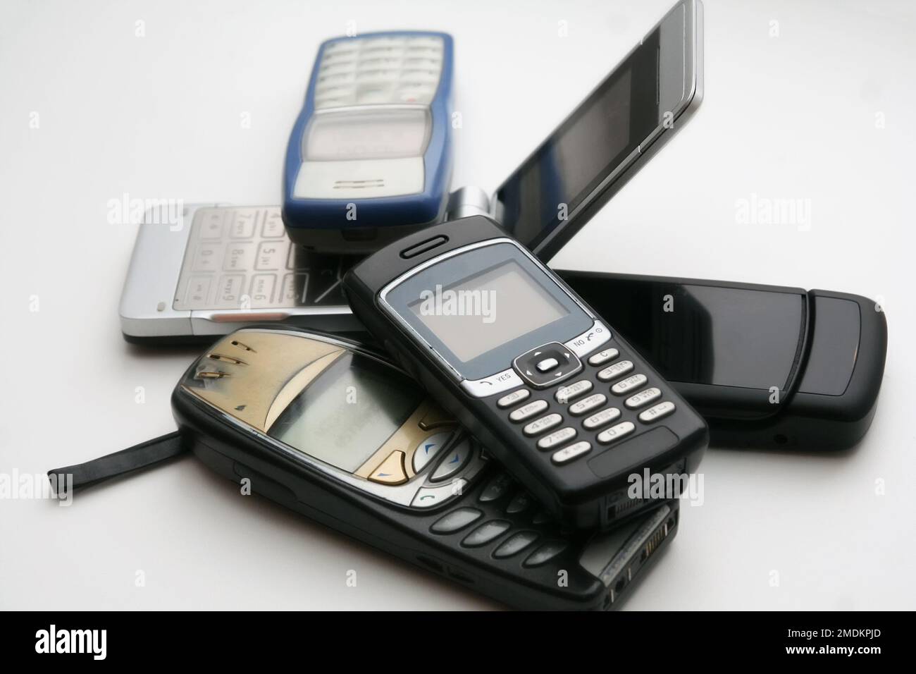 Vintage mobile phones on a light background Stock Photo - Alamy