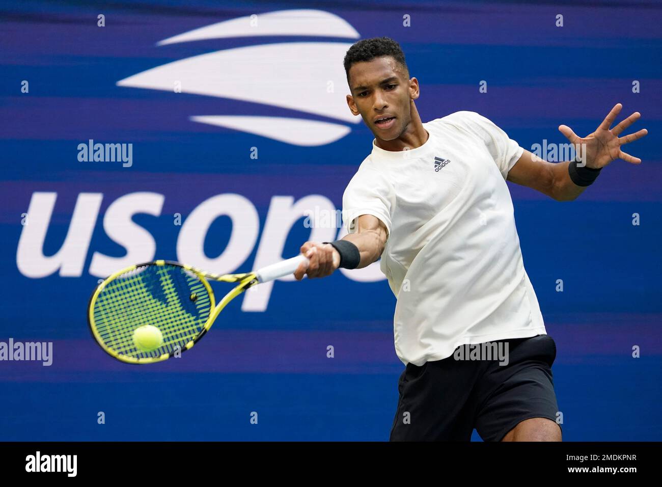 Felix Auger-Aliassime, of Canada, returns a shot to Daniil Medvedev, of Russia, during the ...