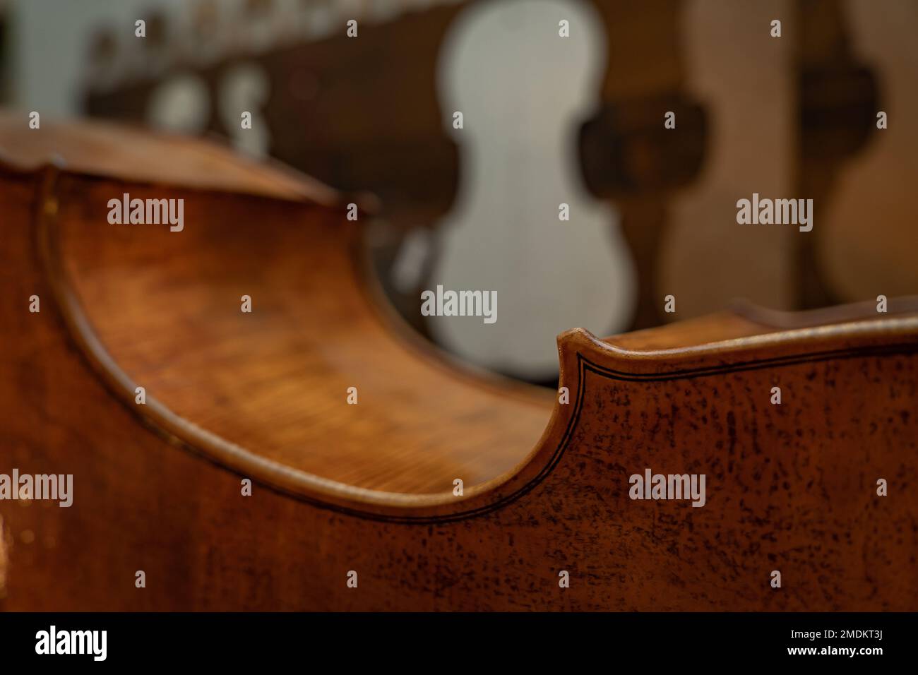 A shallow focus of a violin with its making parts hang on the wall on ...