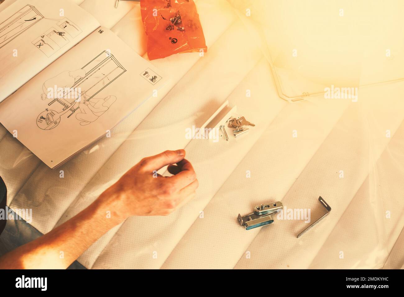 Man reading manual for self assembly furniture Stock Photo - Alamy