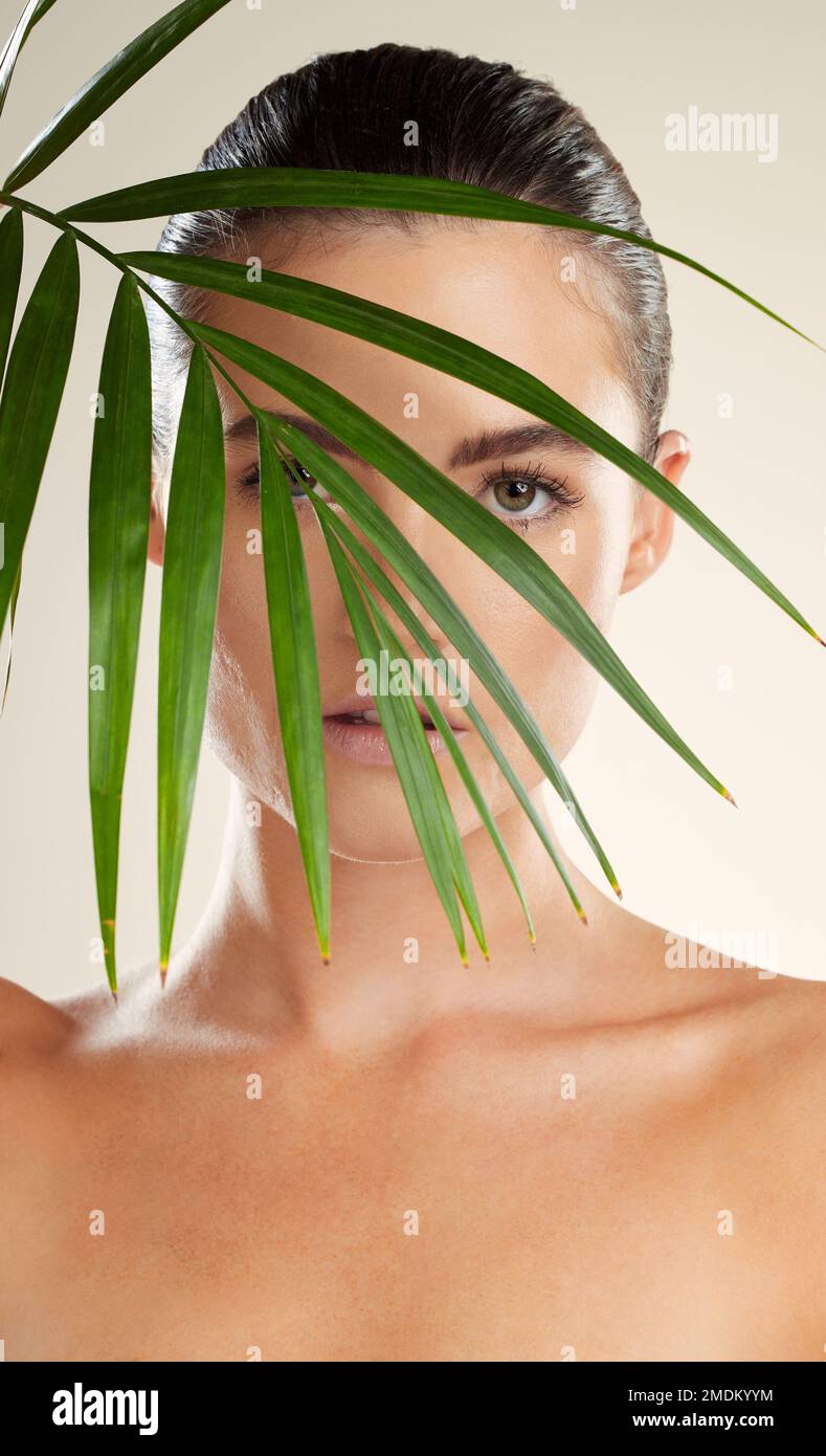 Woman, face and natural beauty with leaf for skincare, cosmetics or ...