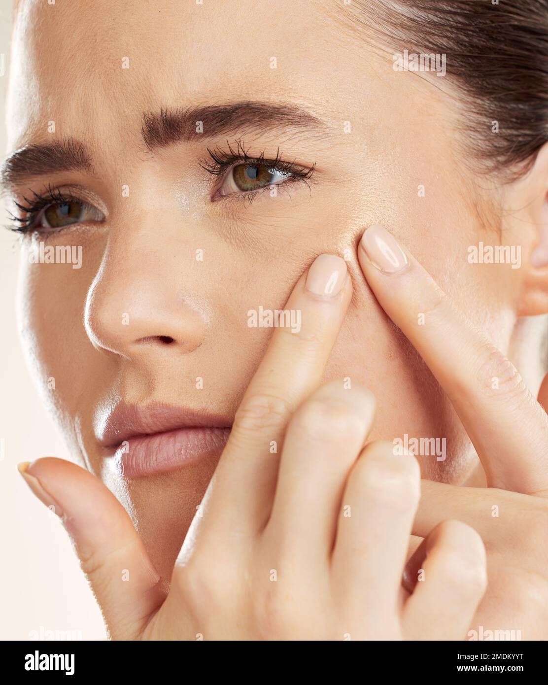 Face, hands and pimple with a woman checking or examining her skin for ...