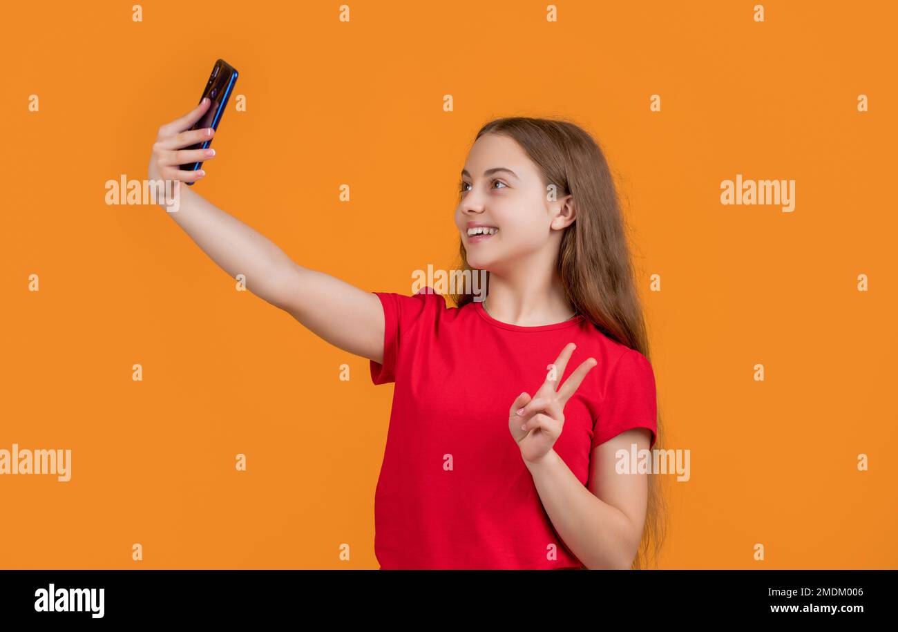 happy kid making selfie on smartphone on yellow background Stock Photo ...