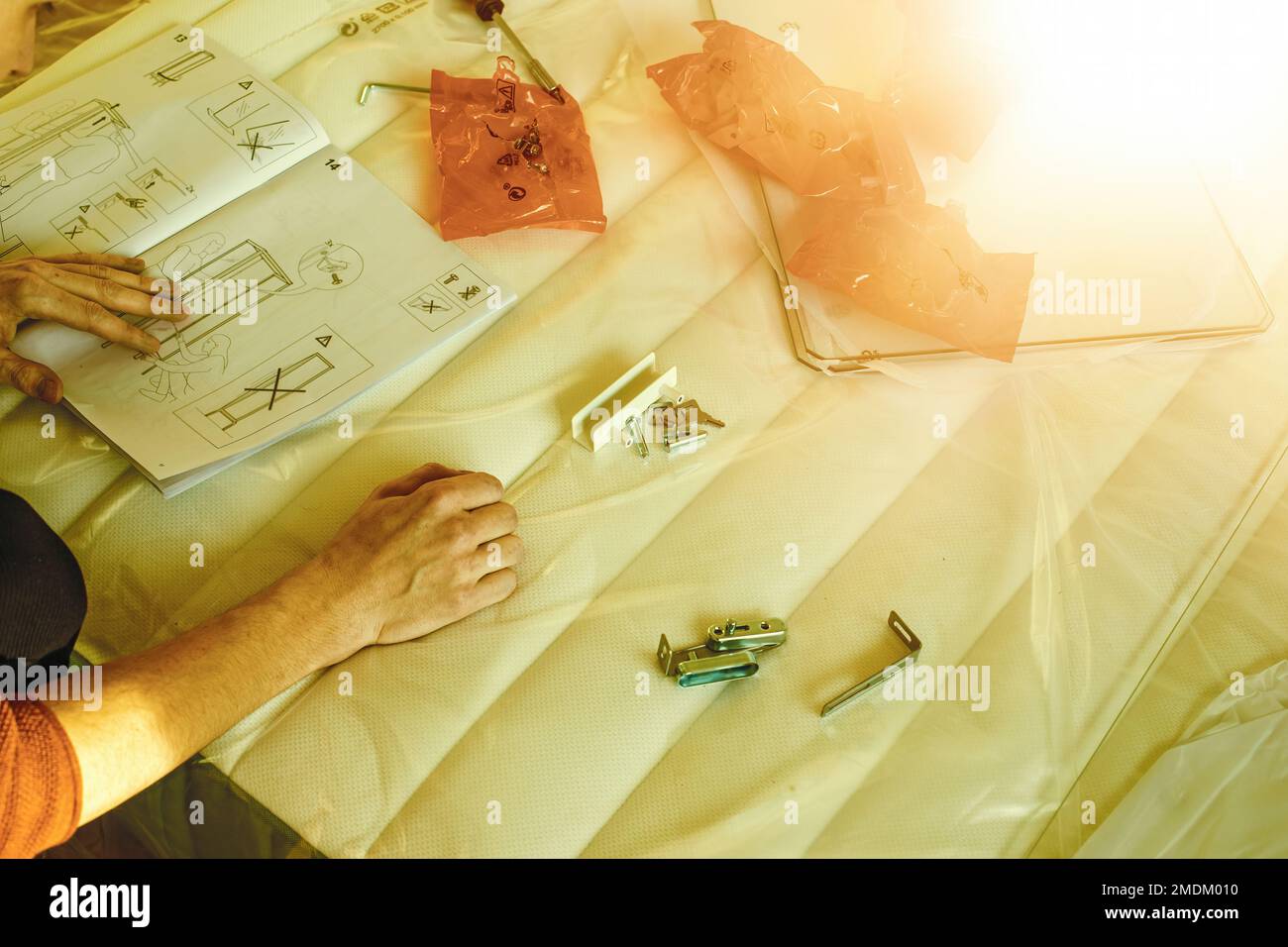 Man reading manual for self assembly furniture Stock Photo - Alamy