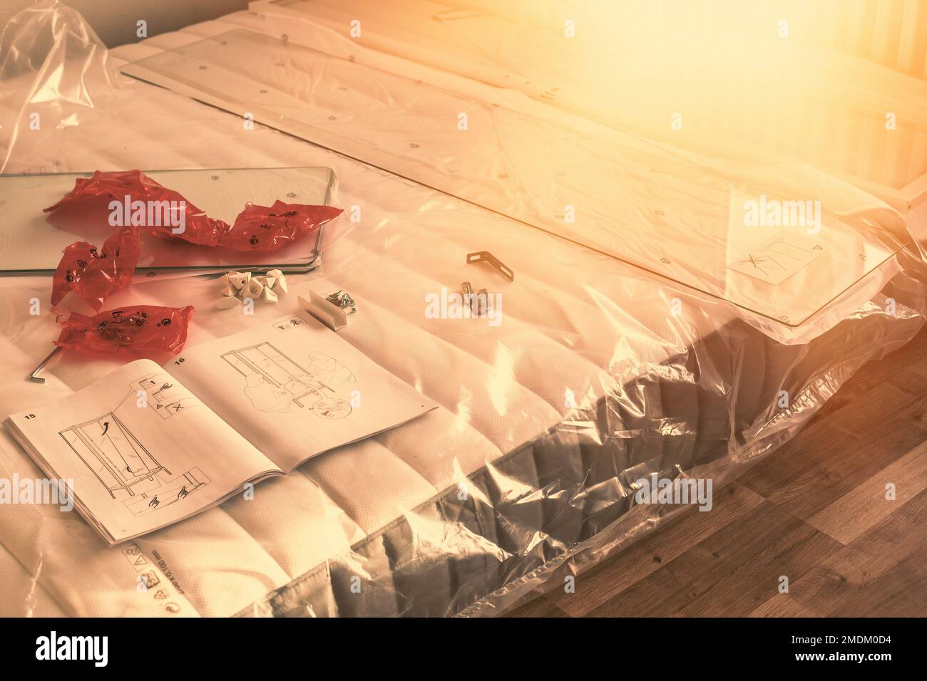 Parts and tools for self assembly furniture lying on mattress Stock ...