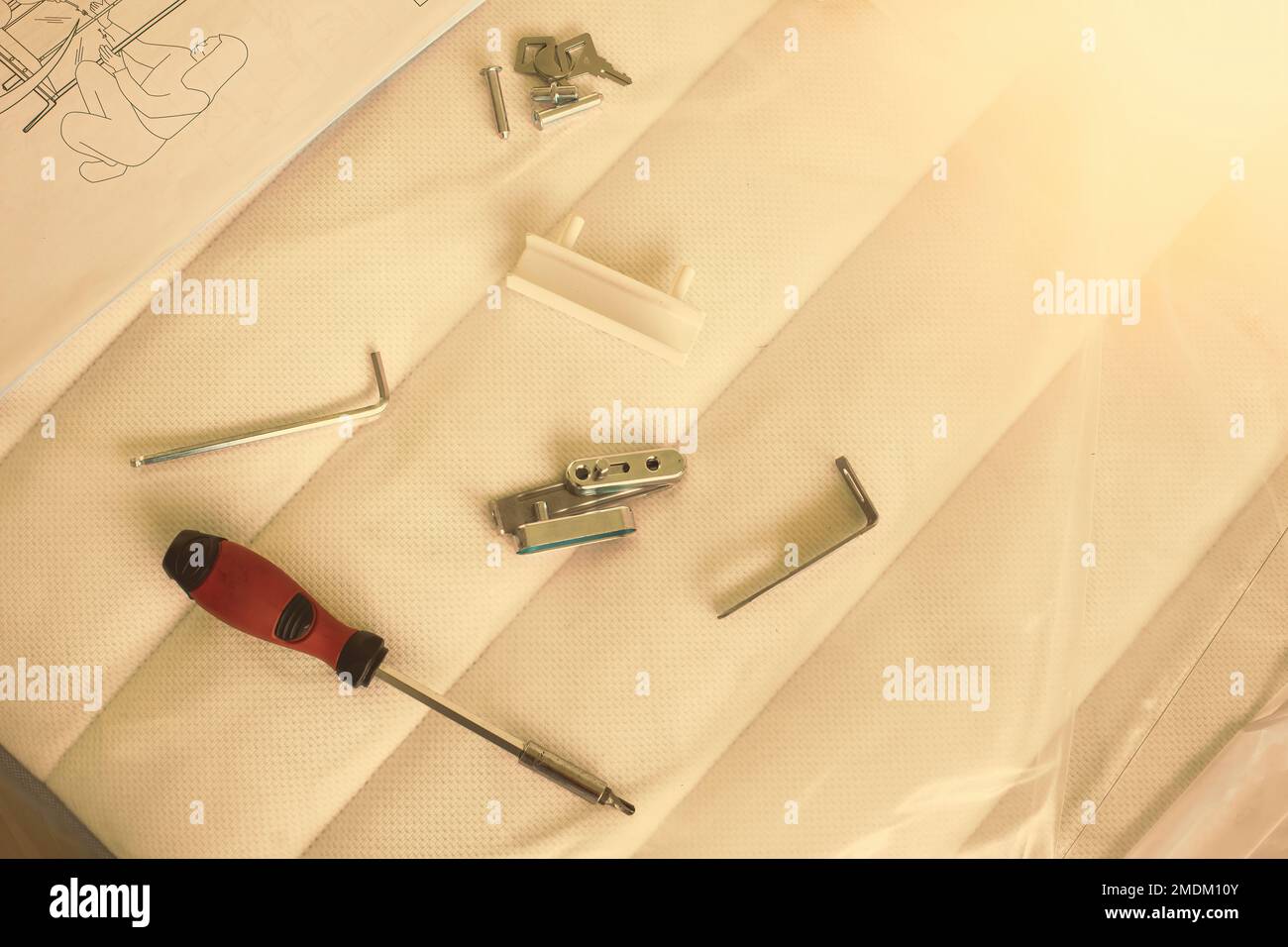 Parts and tools for self assembly furniture lying on mattress Stock ...