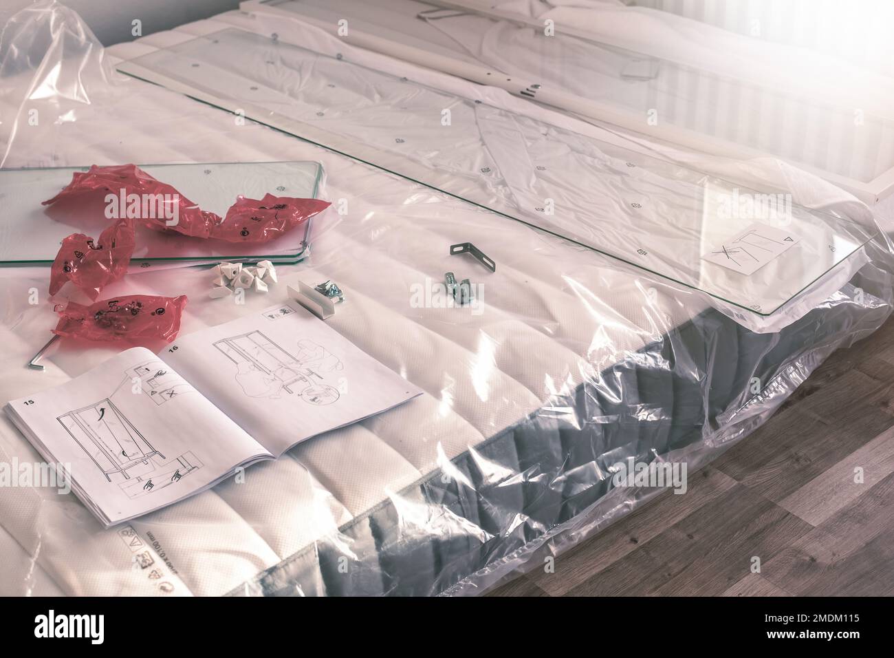 Parts and tools for self assembly furniture lying on mattress Stock ...