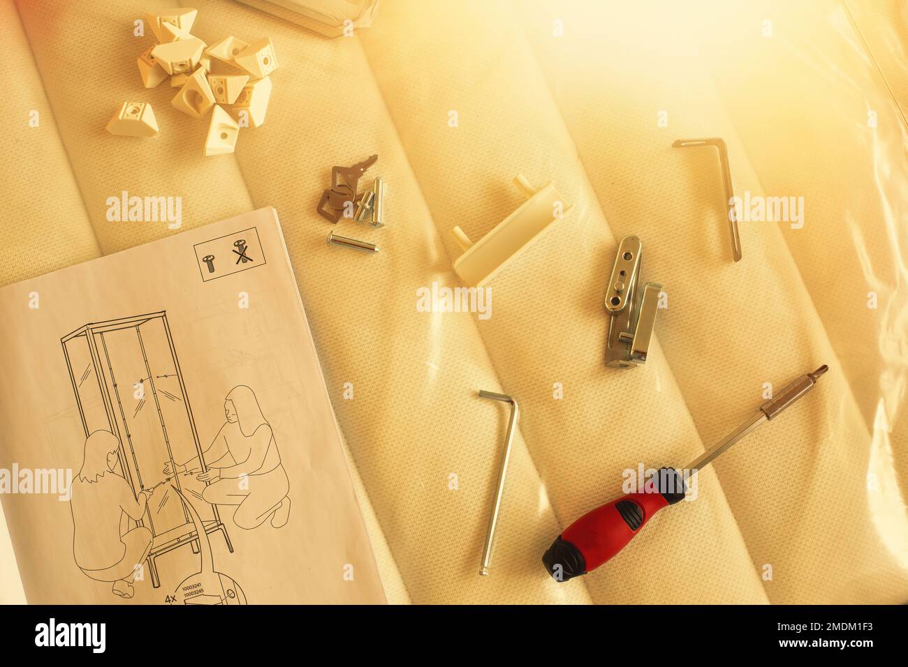 Parts and tools for self assembly furniture lying on mattress Stock ...