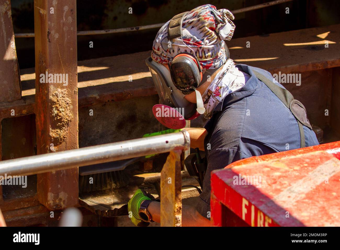 A Job Corps member cleans on deck the hopper dredge, Essayons, while ...