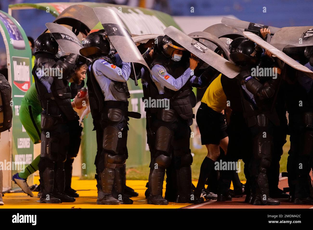 Police shield United States' players as they leave the field after a ...