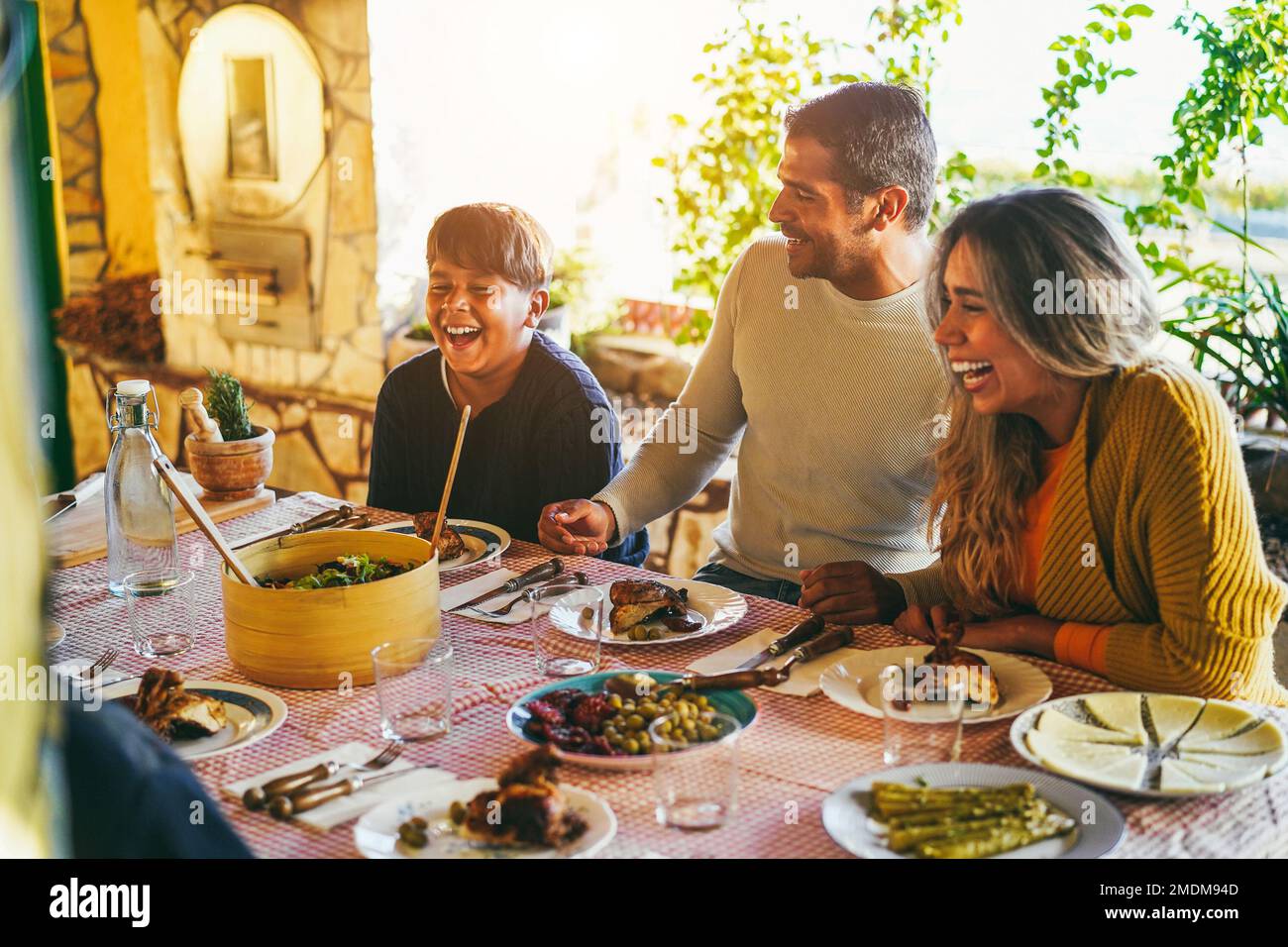 Happy latin family having fun eating together during home dinner - Soft ...