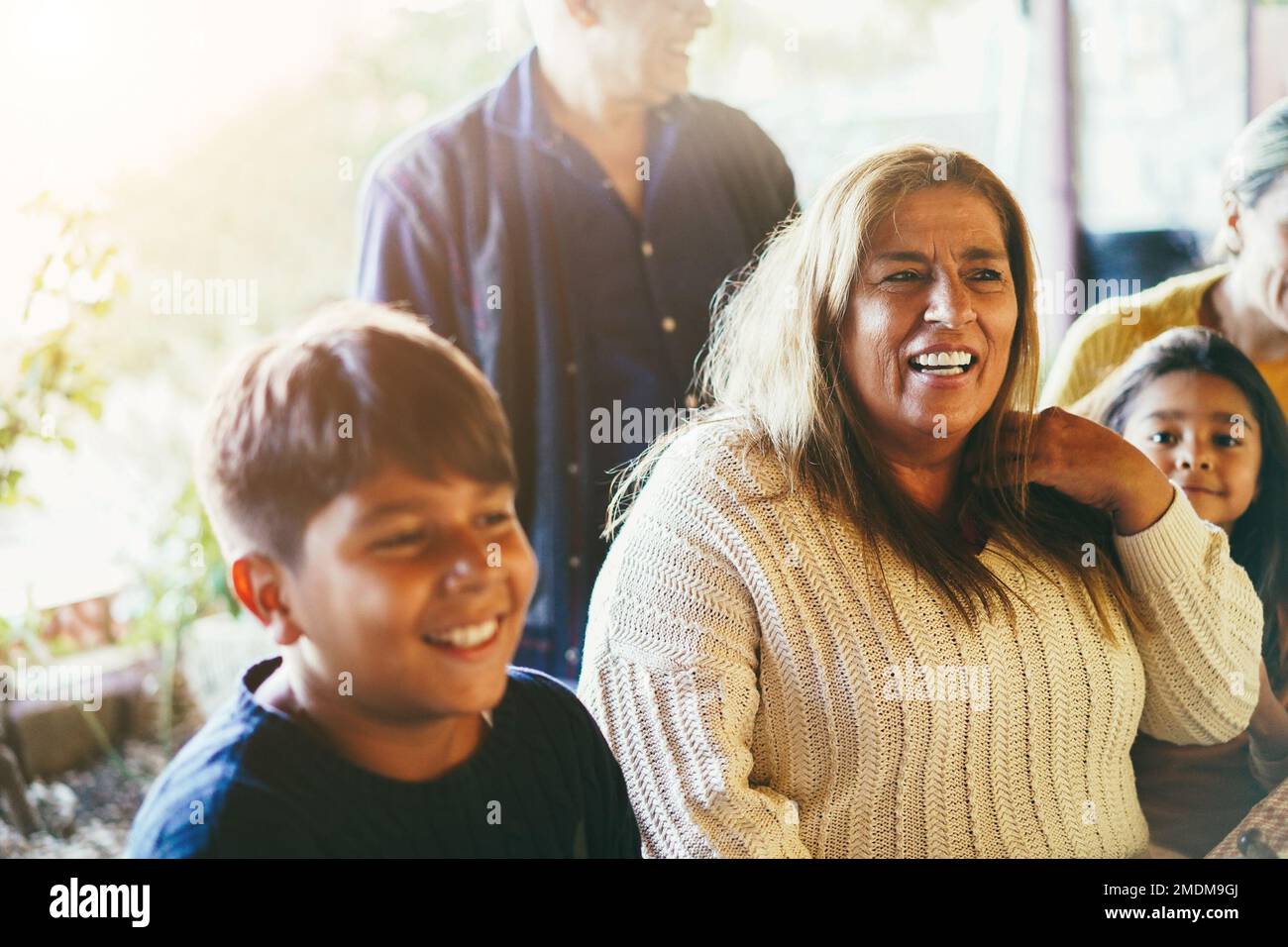 Happy latin family having fun together at home - Soft focus on ...