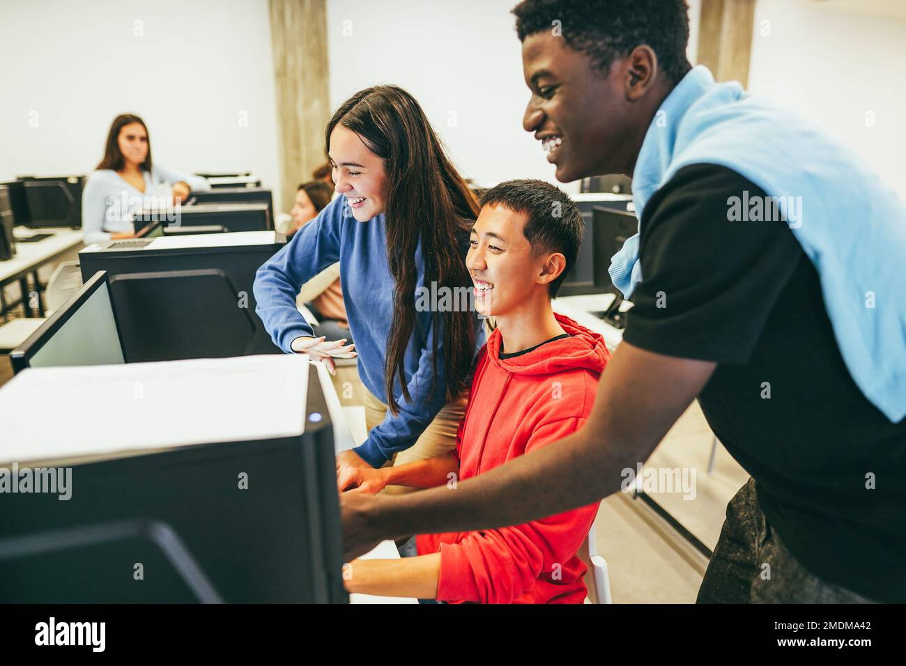 Young multiracial students using computers inside technology class at ...