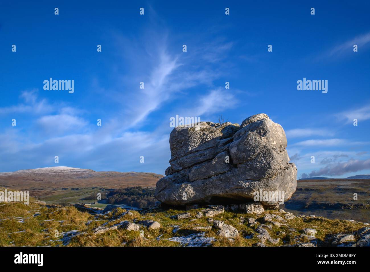 A large erratic boulder on Keld Head Scar with Whernside in the ...