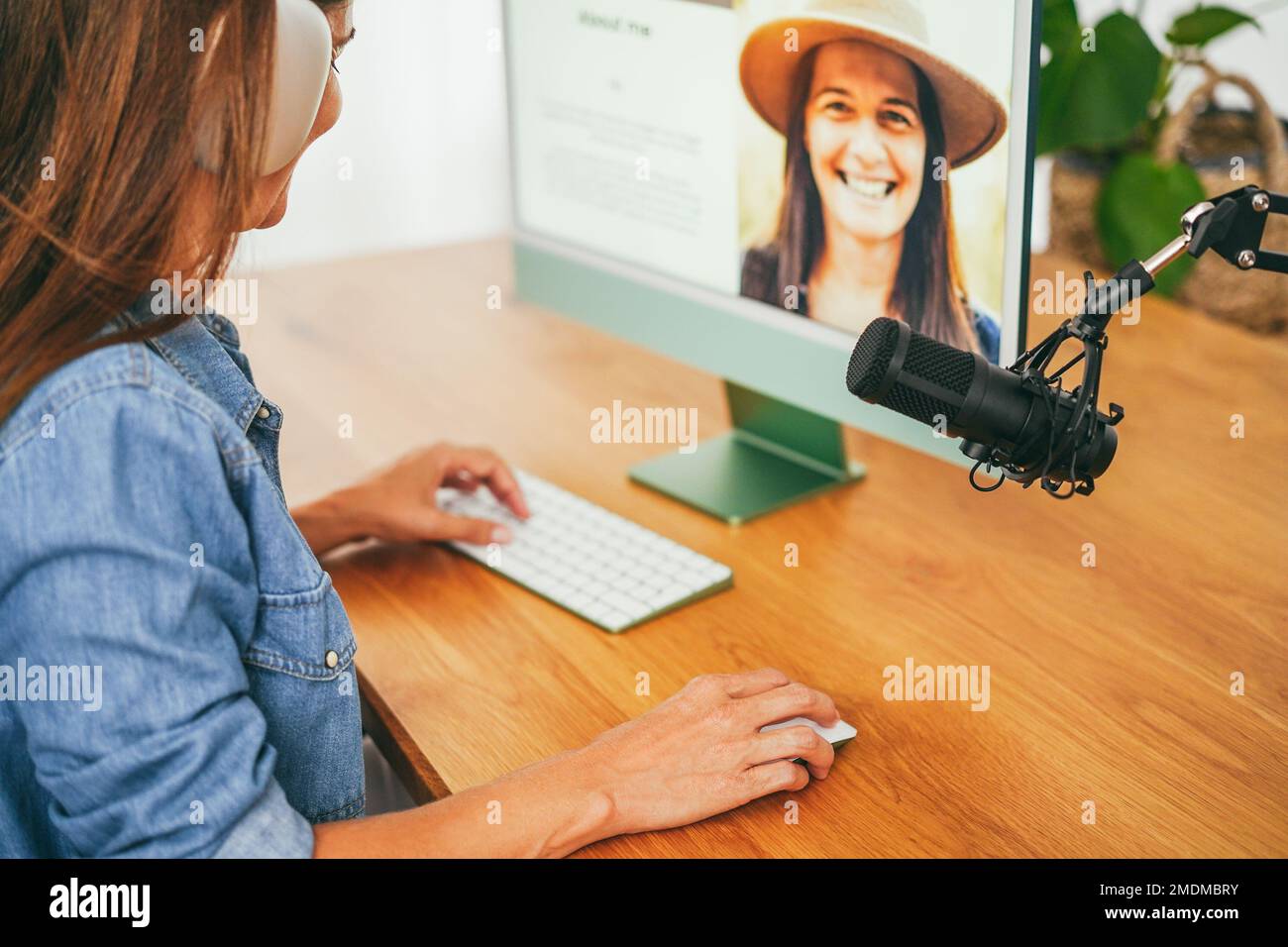 Influencer woman doing podcast using computer at home - Technology ...