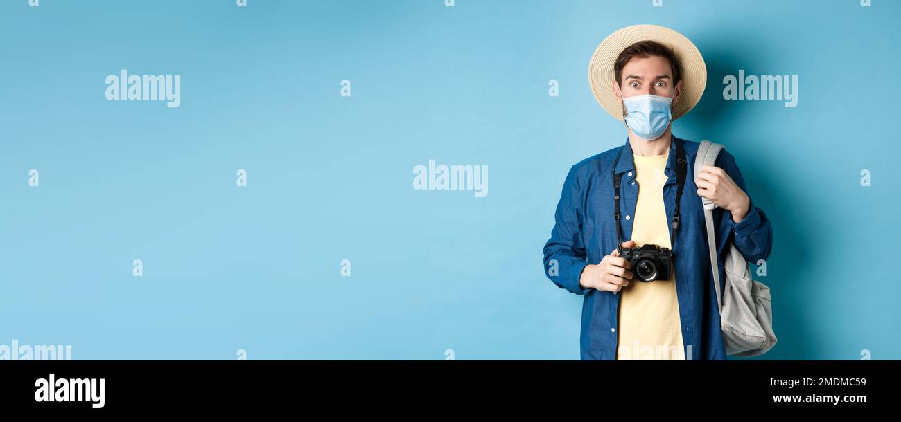 Covid-19 and summer holidays concept. Excited tourist in straw hat and ...