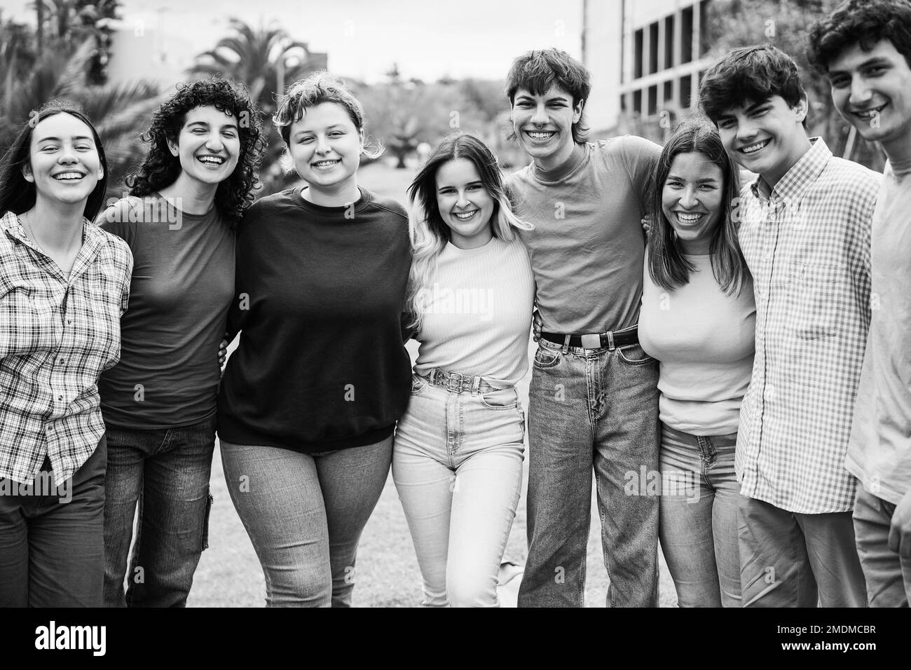 Young group of friends having fun outdoor with university on background ...