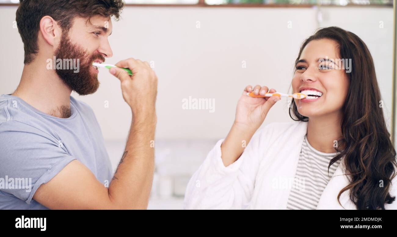 Who said routine has to be boring. a happy young couple brushing their ...
