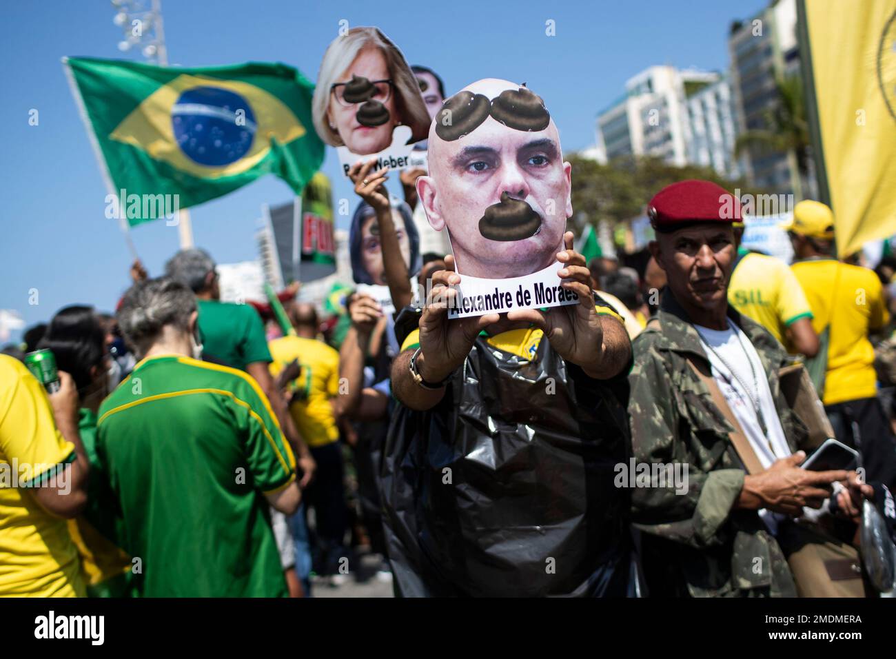 Supporters hold cutouts depicting Supreme Court justices with pile of ...