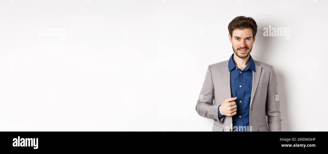 Confident businessman in suit smiling at camera, standing self-assured ...