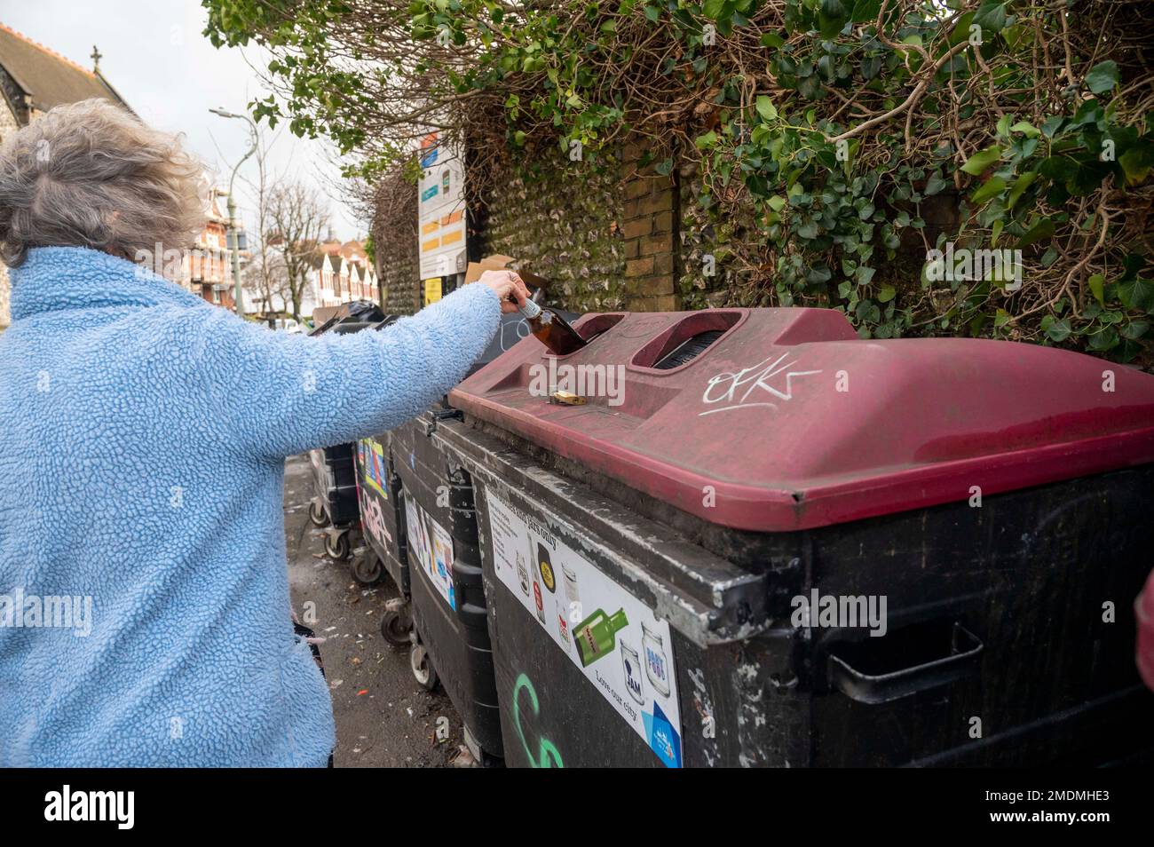 Recycling household waste UK - Woman disposing of household rubbish at ...