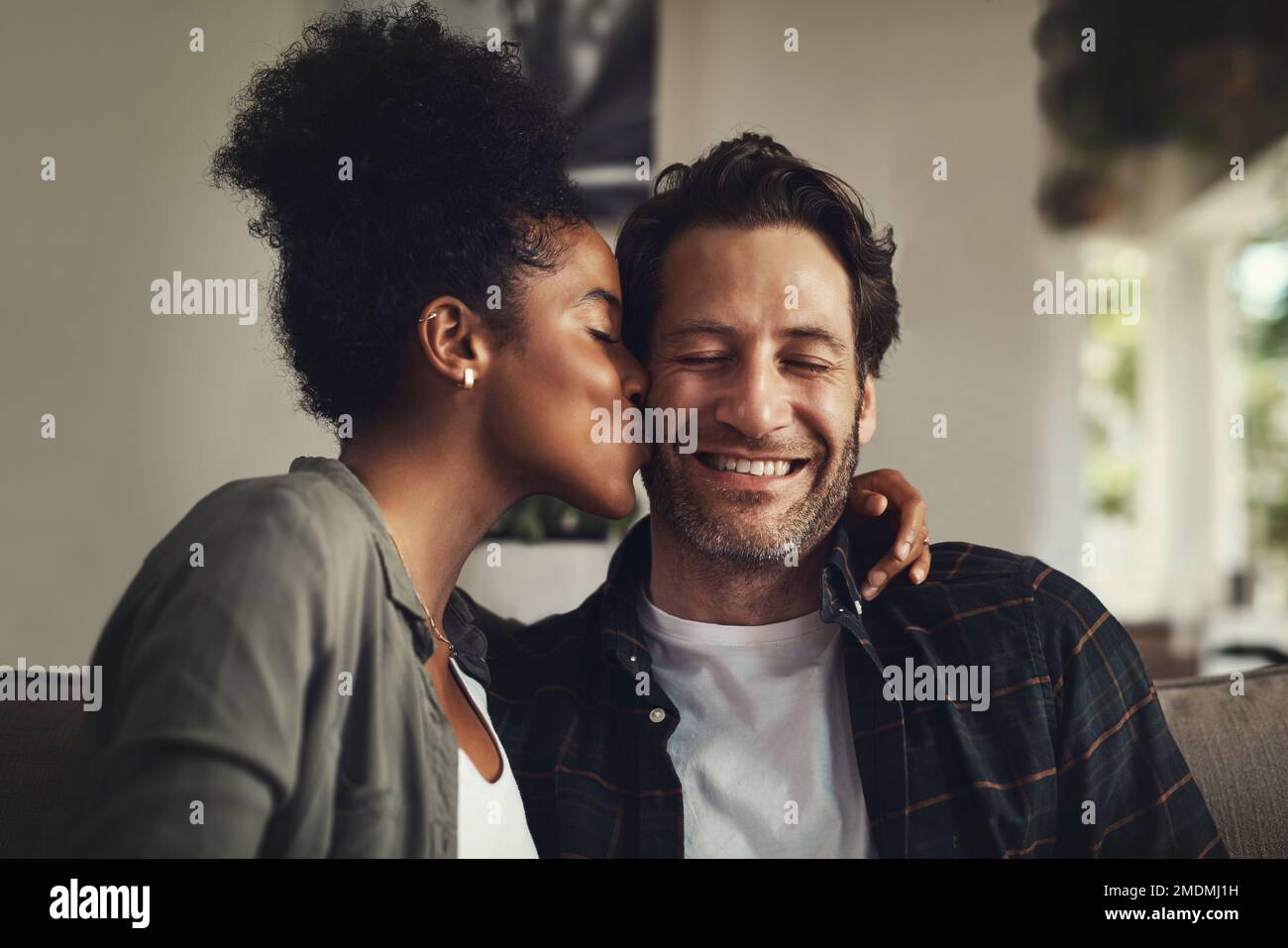 Let tender kisses bleed. a young woman kissing her boyfriend on the ...