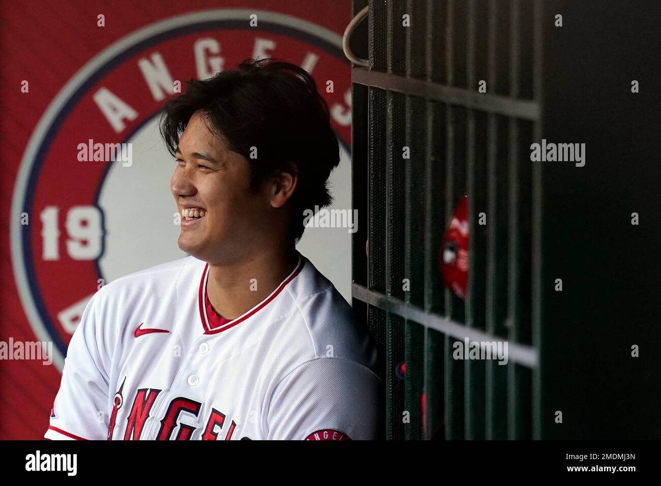 Los Angeles Angels' Shohei Ohtani smiles in the dugout during the first ...