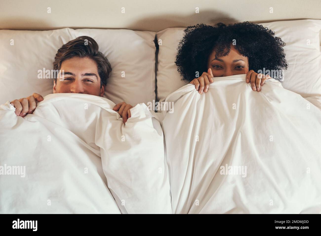 We see you. High angle shot of a playful young couple covering ...