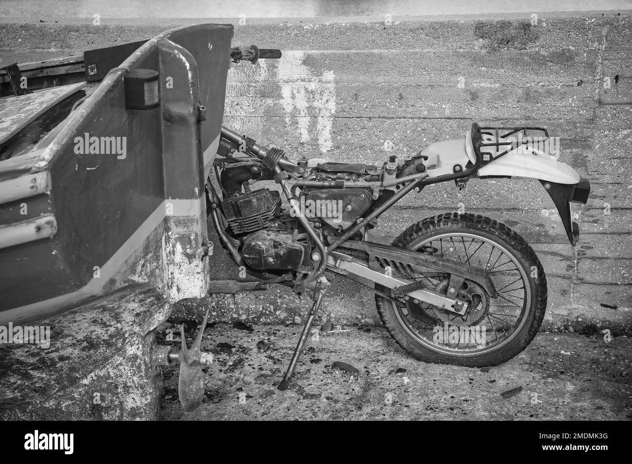 Old stationary motorcycle leaning on wall in Black & White . Stock ...