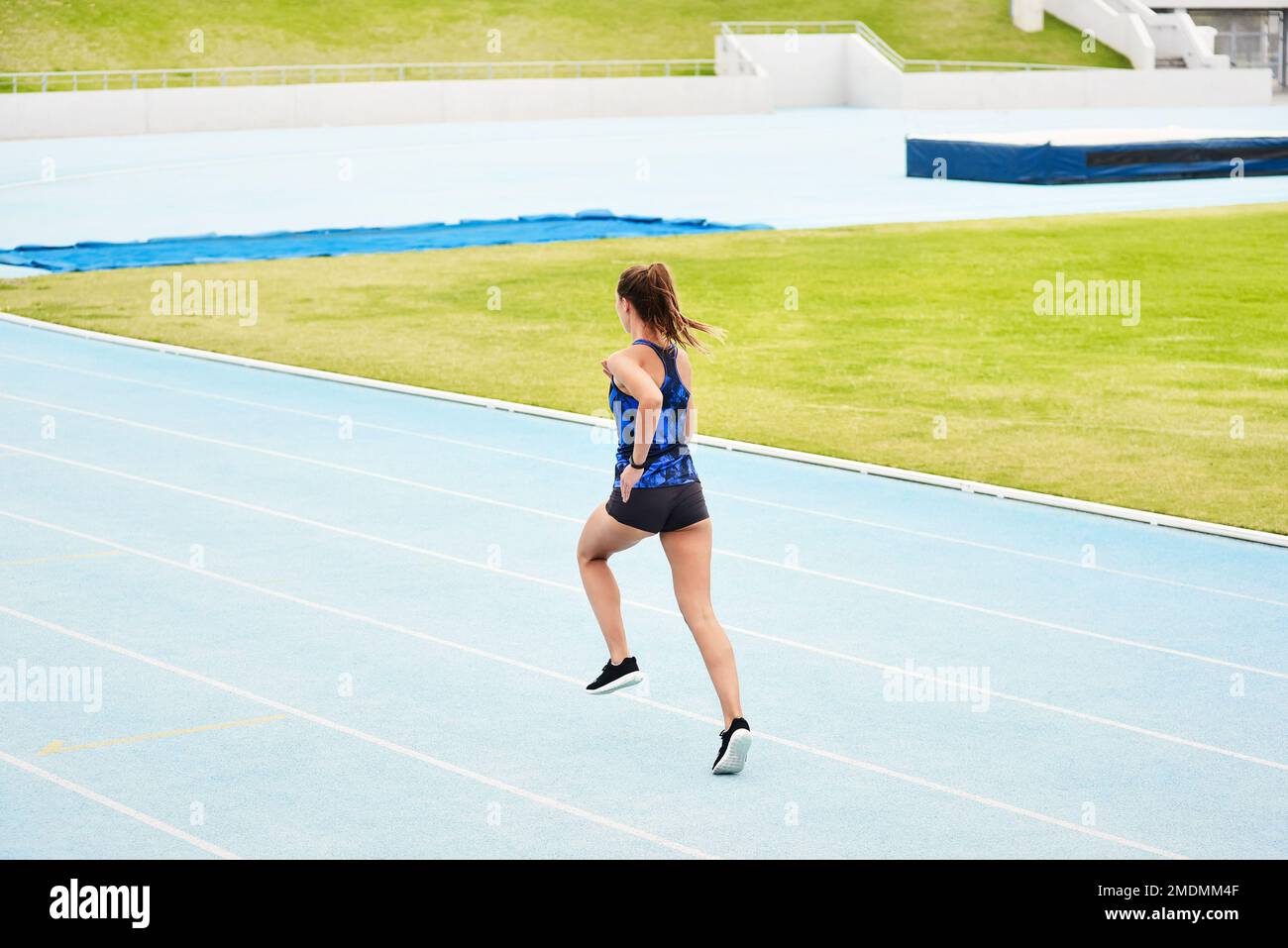 Shes got a need for speed. Rearview shot of an unrecognizable young ...