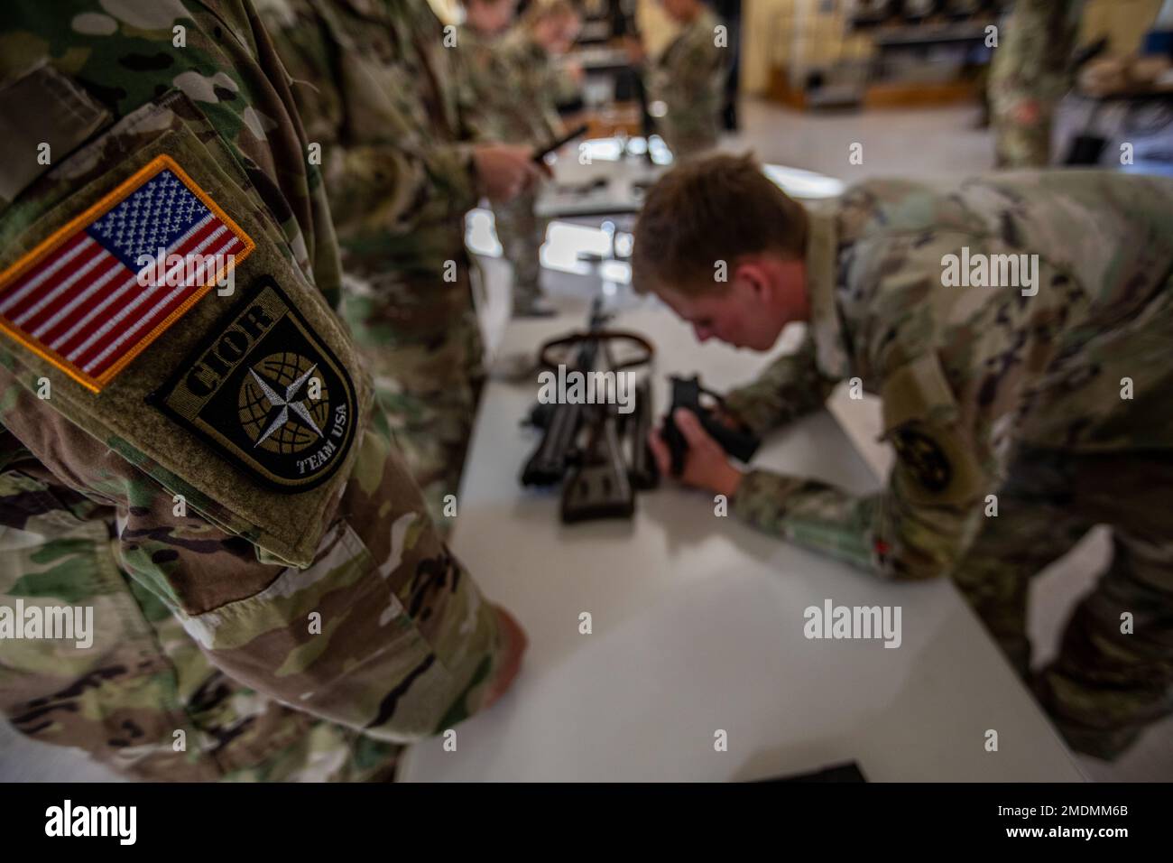 CIOR teammates look on as Army Reserve Cpl. Ethan Allen, Army Reserve ...