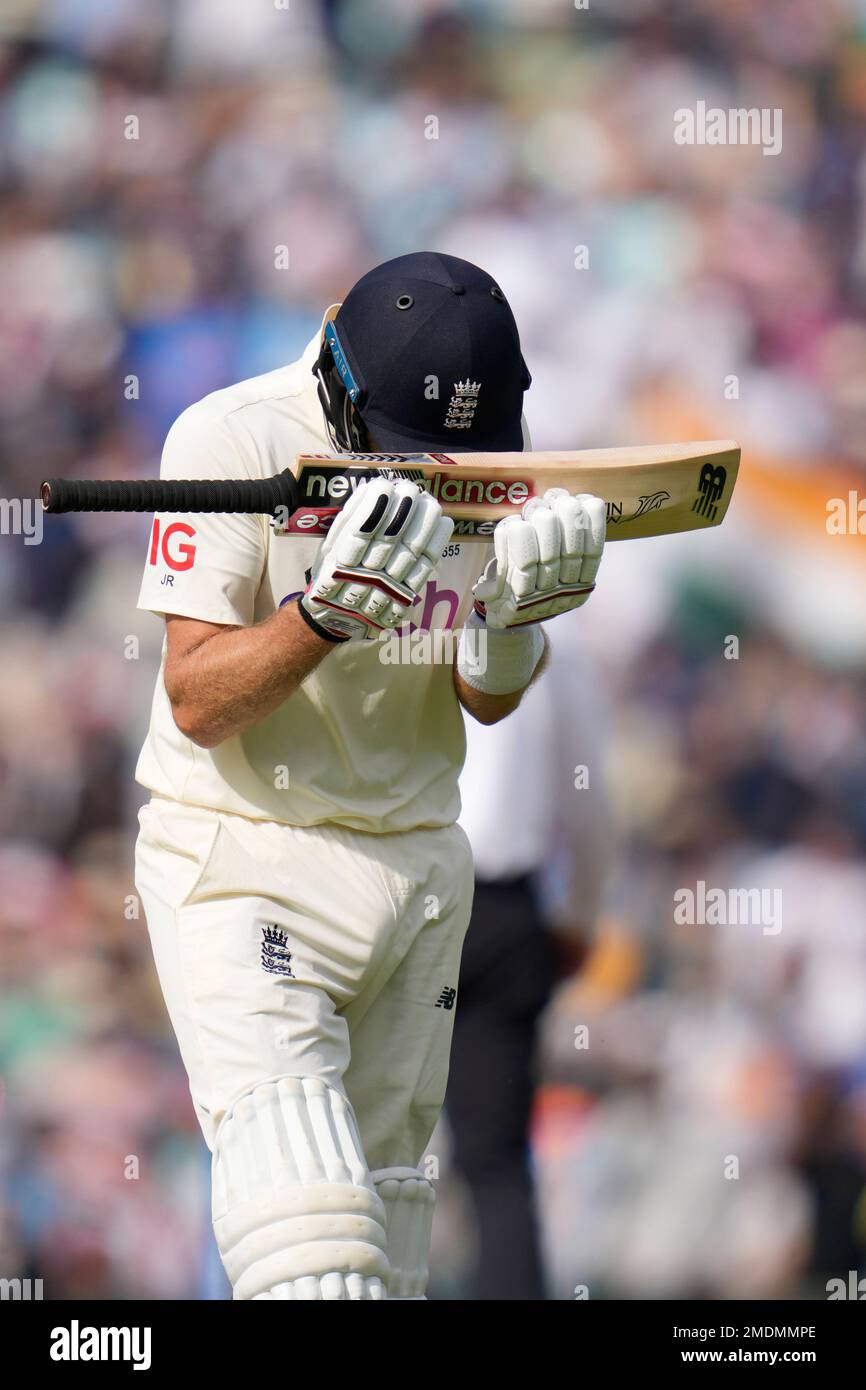 England's Joe Root puts his head on his bat as he leaves the pich after ...