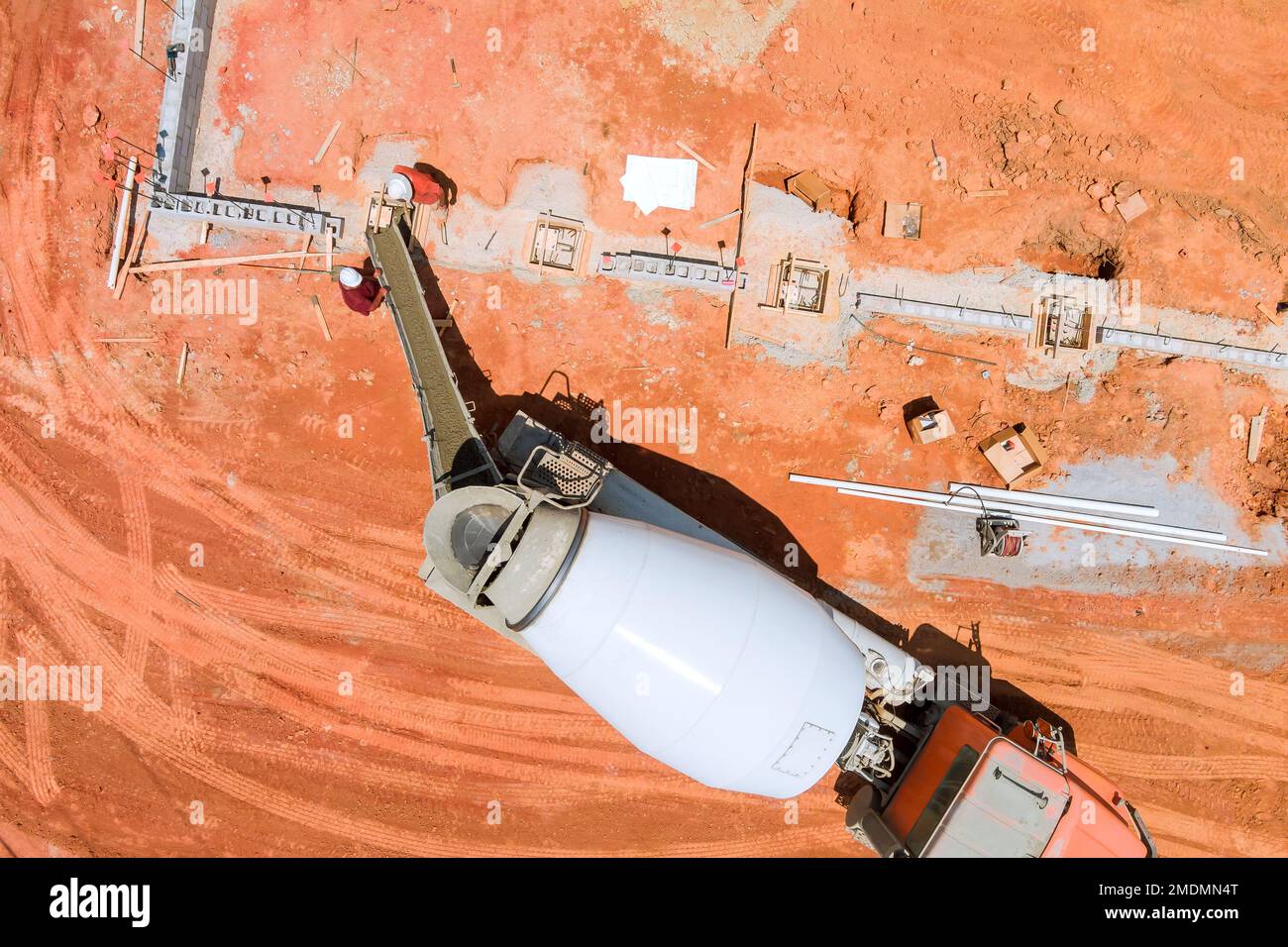 In order to prepare for concrete pouring process worker is using mixer ...