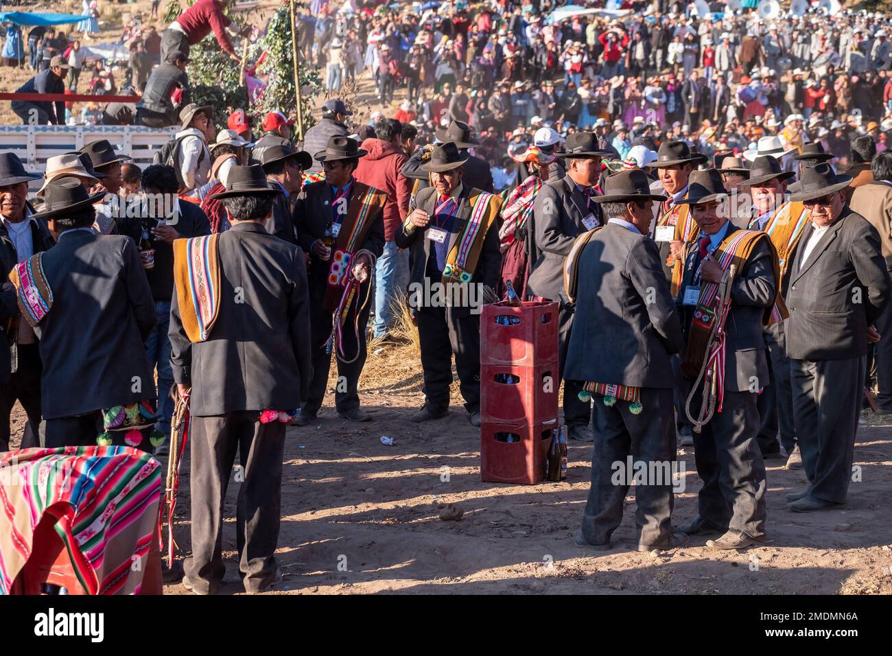 Men wearing black suits an hats, with peruvian fabrics on their ...
