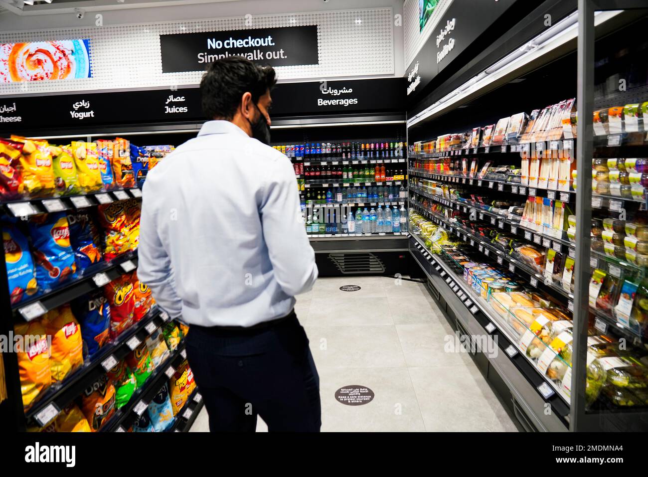 A Carrefour employee walks through Carrefour's new cashier-less grocery ...