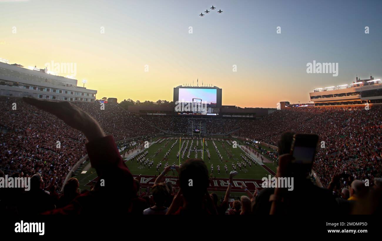 Fighter jets fly over the stadium before the start of an NCAA college ...
