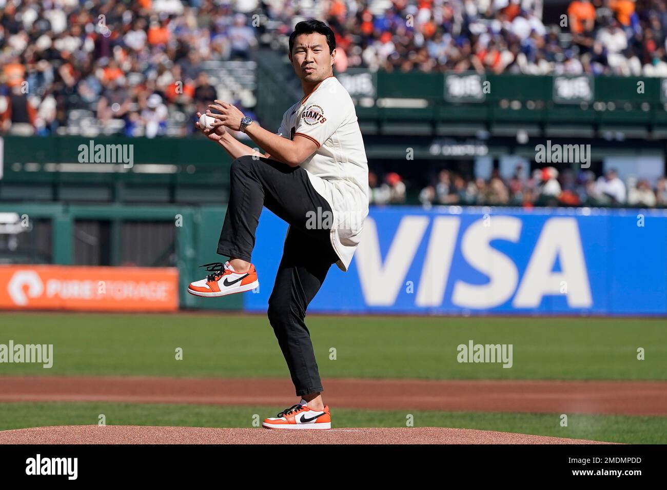 Actor Simu Liu throws out the ceremonial first pitch before a baseball ...