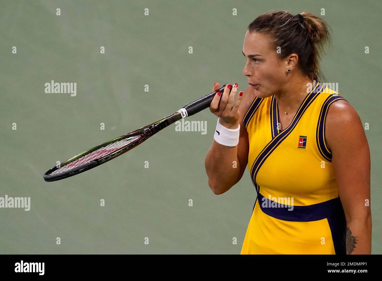 Aryna Sabalenka, of Belarus, blows on her racket while playing Elise ...
