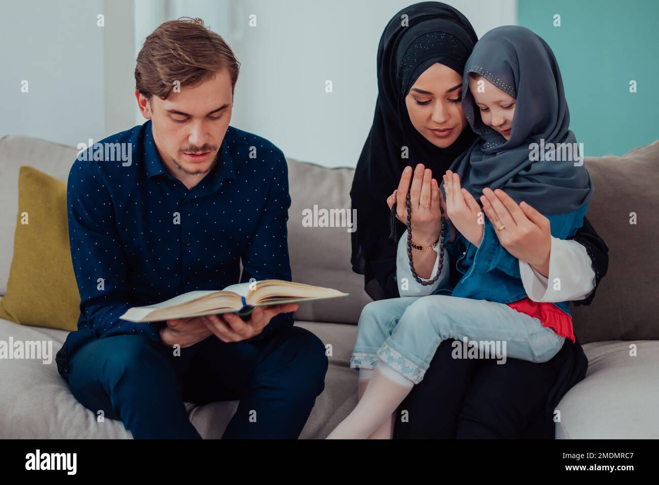 Happy Muslim family enjoying the holy month of Ramadan while praying ...