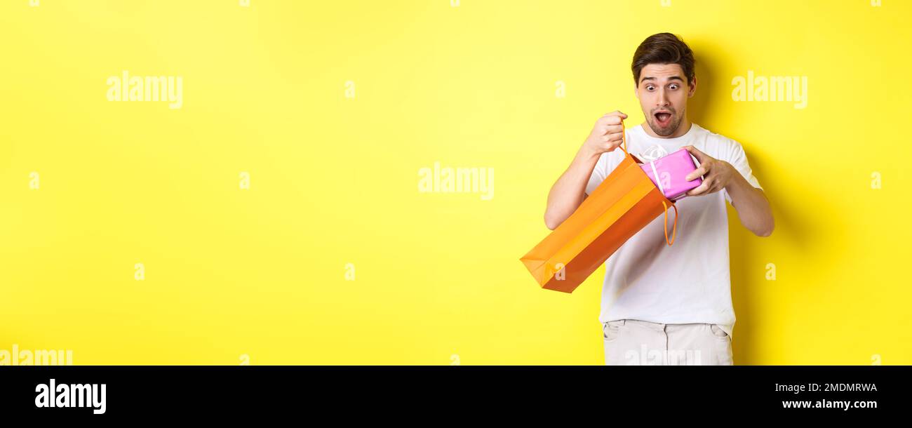 Concept of holidays and celebration. Young man looking surprised as ...