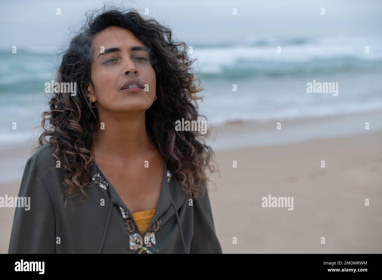 Woman blowing smoke with blurred background Stock Photo - Alamy