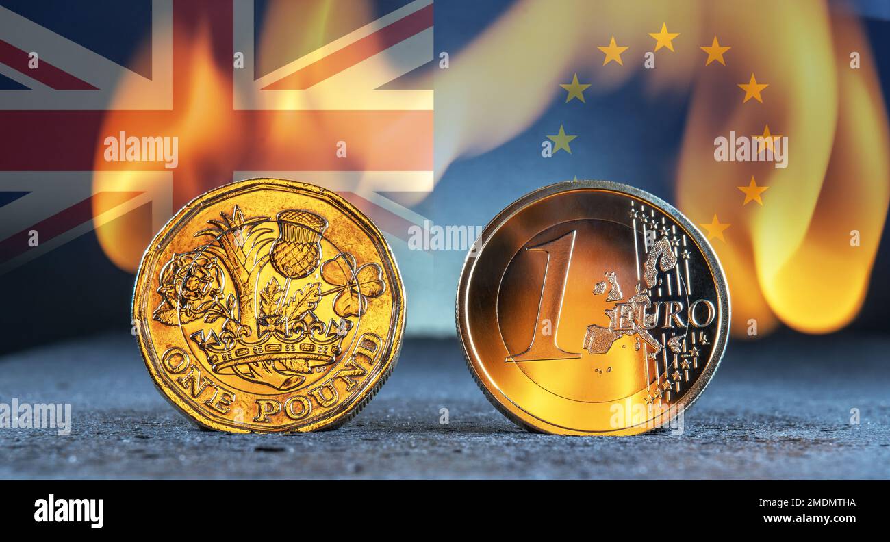 One Pound coin with one Euro coin standing side by side in front of ...