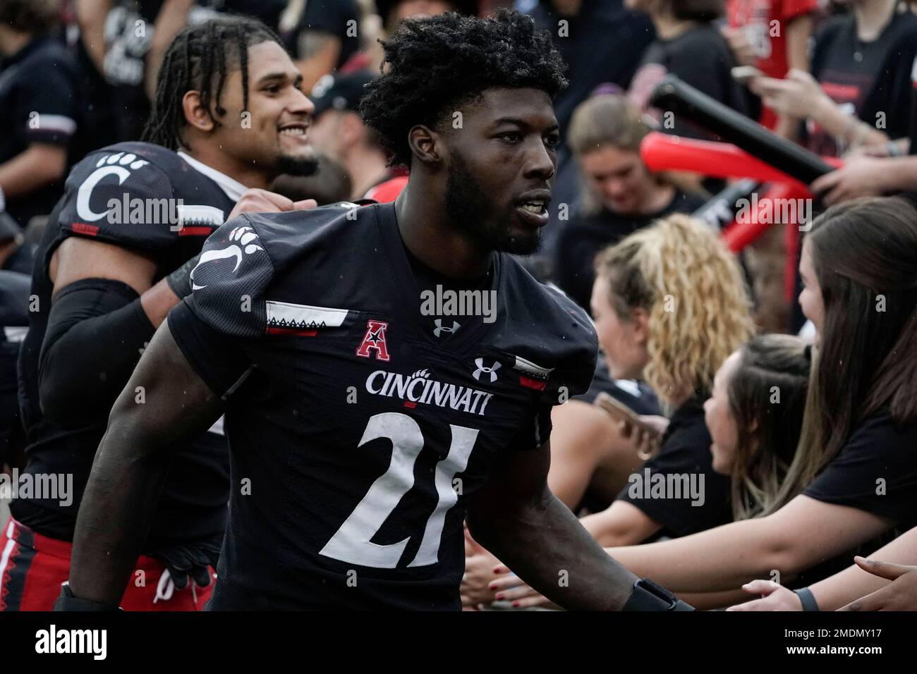 Cincinnati defensive lineman Myjai Sanders (21) celebrates with fans ...